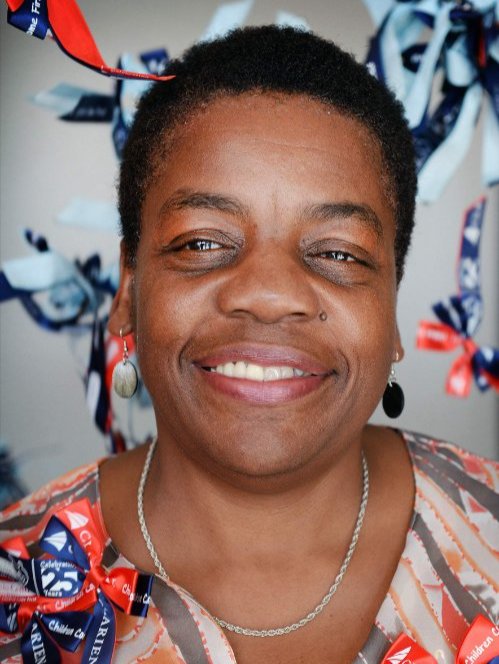 showing off her Cup Match Team colours with Family Centre ribbons, a ...